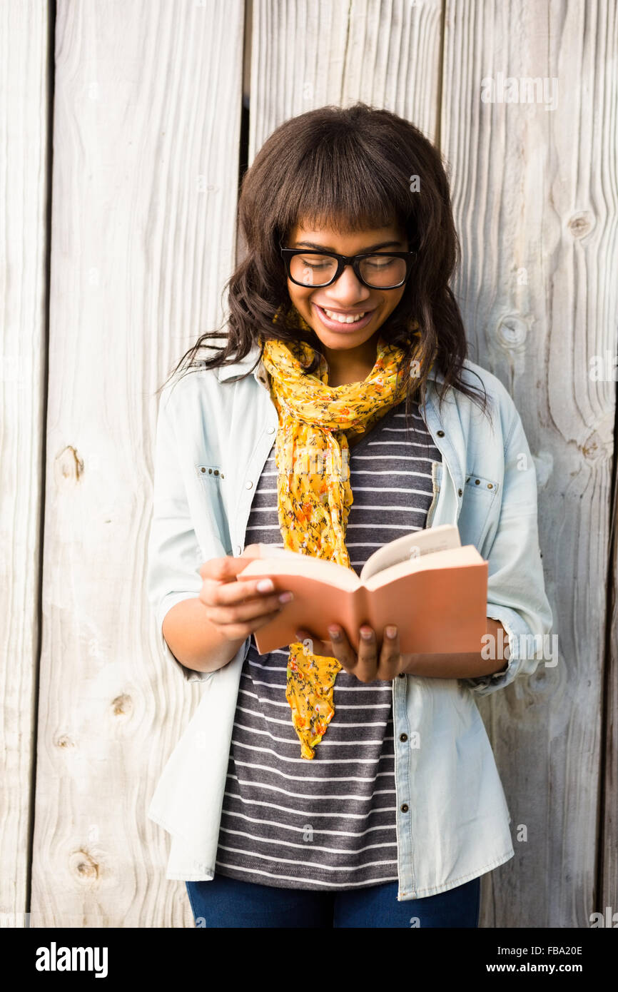 Smiling casual woman reading a book Stock Photo - Alamy
