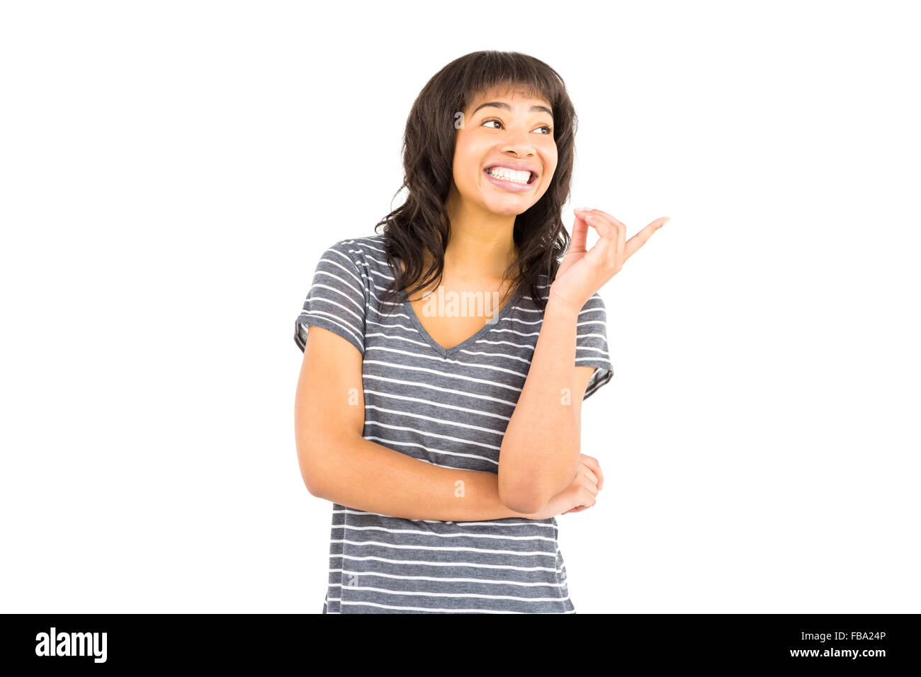 Smiling casual woman pointing somethings in the air Stock Photo - Alamy