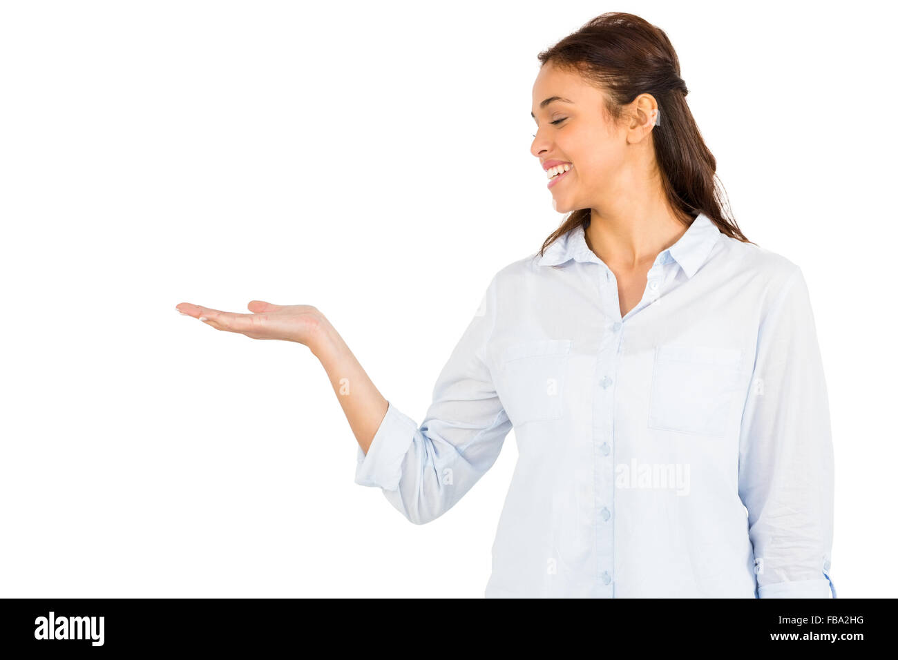 Smiling woman presenting something Stock Photo - Alamy