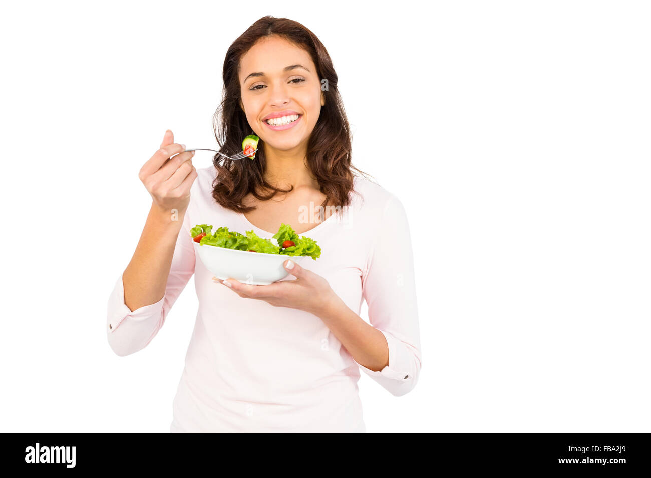 Pretty smiling woman eating salad Stock Photo - Alamy