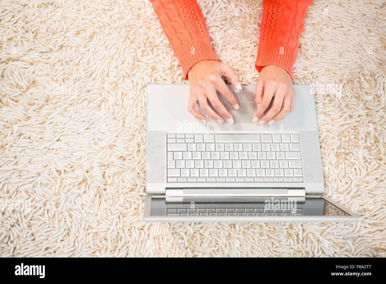 Woman using laptop while lying on the floor Stock Photo - Alamy