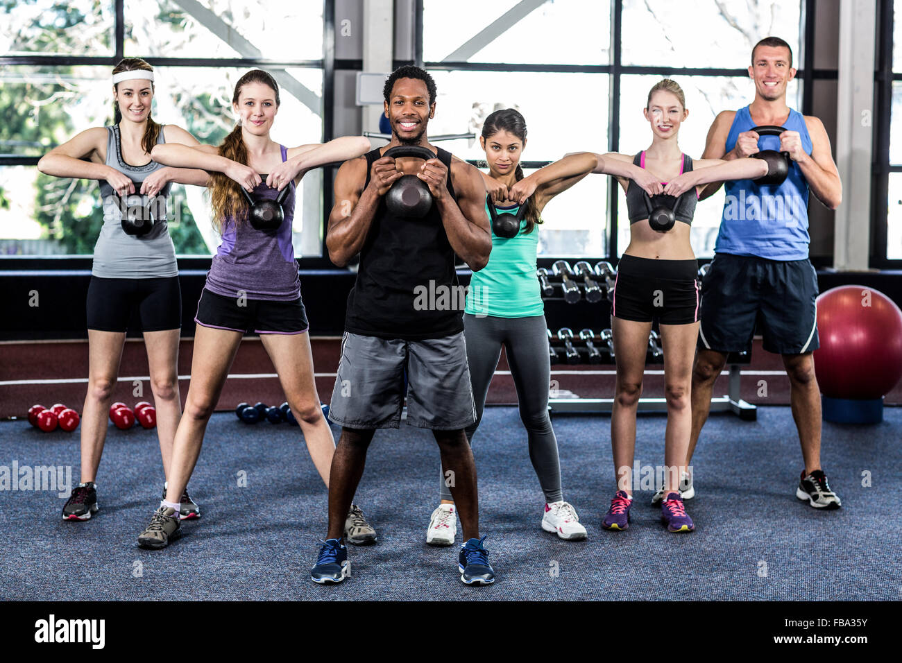 Class and instructor exercising with kettlebells Stock Photo - Alamy