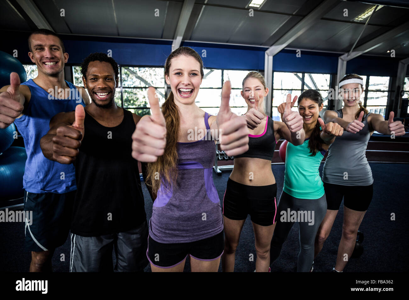 Posing smiling thumbs up hi-res stock photography and images - Alamy