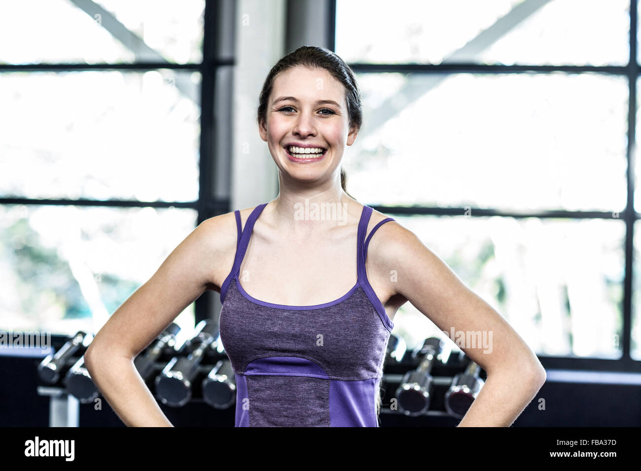 Smiling woman posing with hands on hips Stock Photo - Alamy
