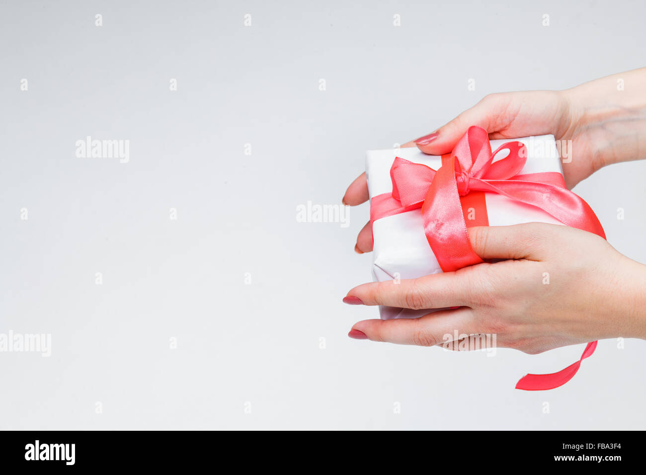 Female hands holding gift box Stock Photo - Alamy