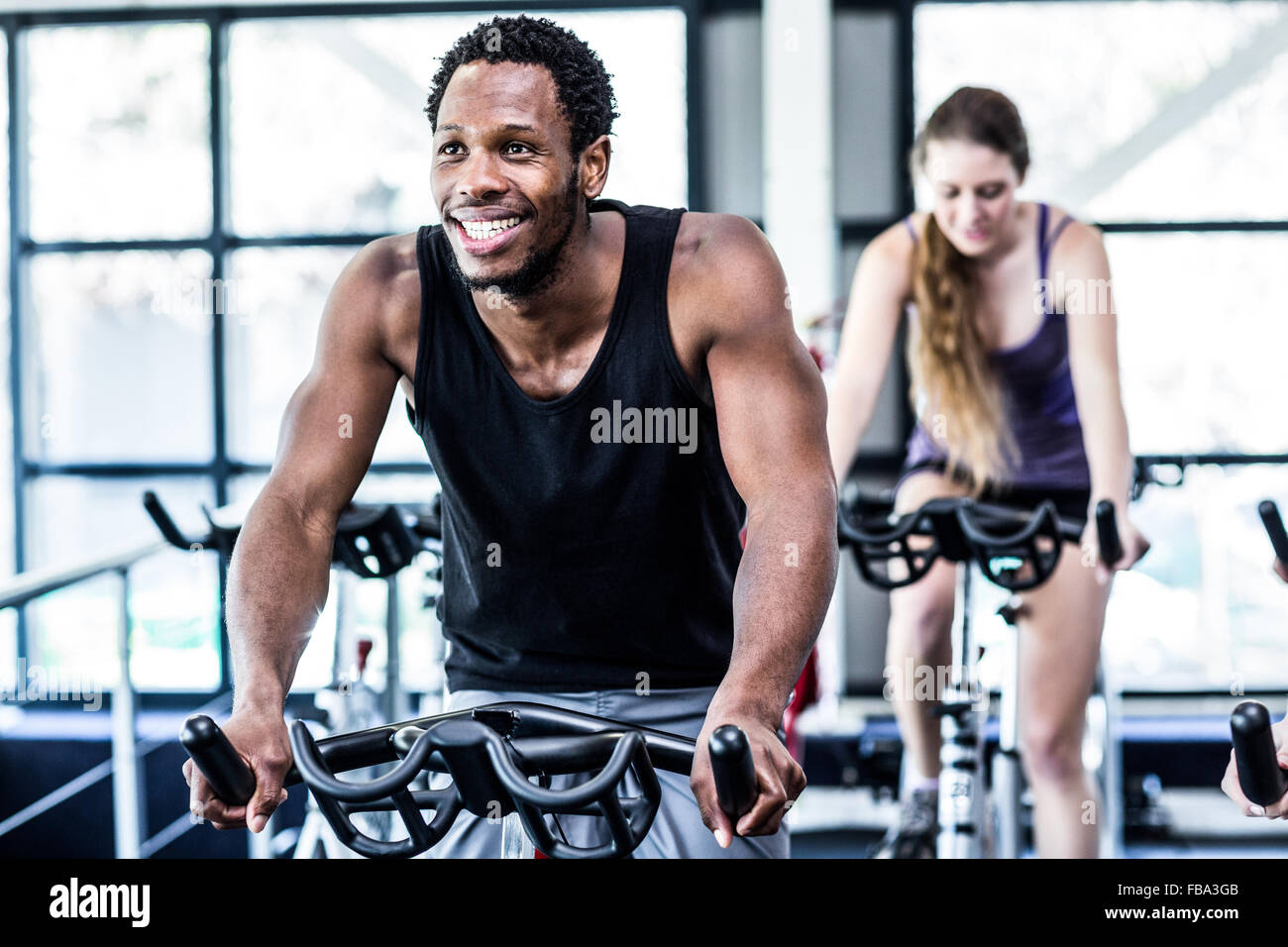 Fit man working out at spinning class Stock Photo - Alamy