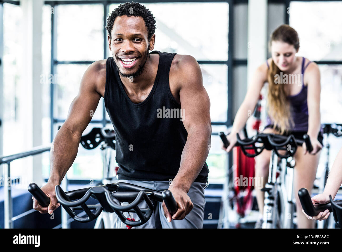Fit man working out at spinning class Stock Photo - Alamy