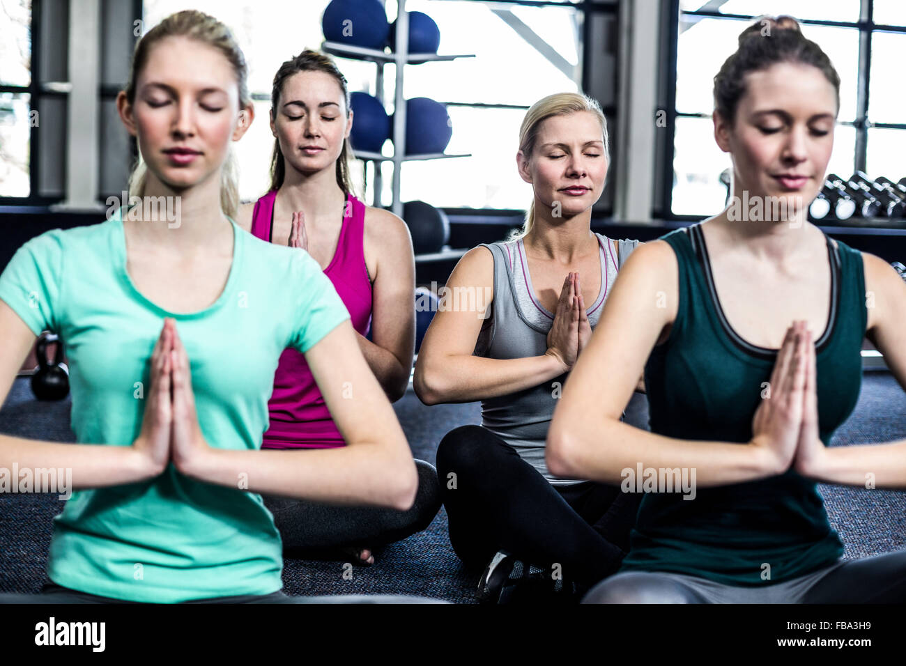 Fit group doing yoga Stock Photo - Alamy