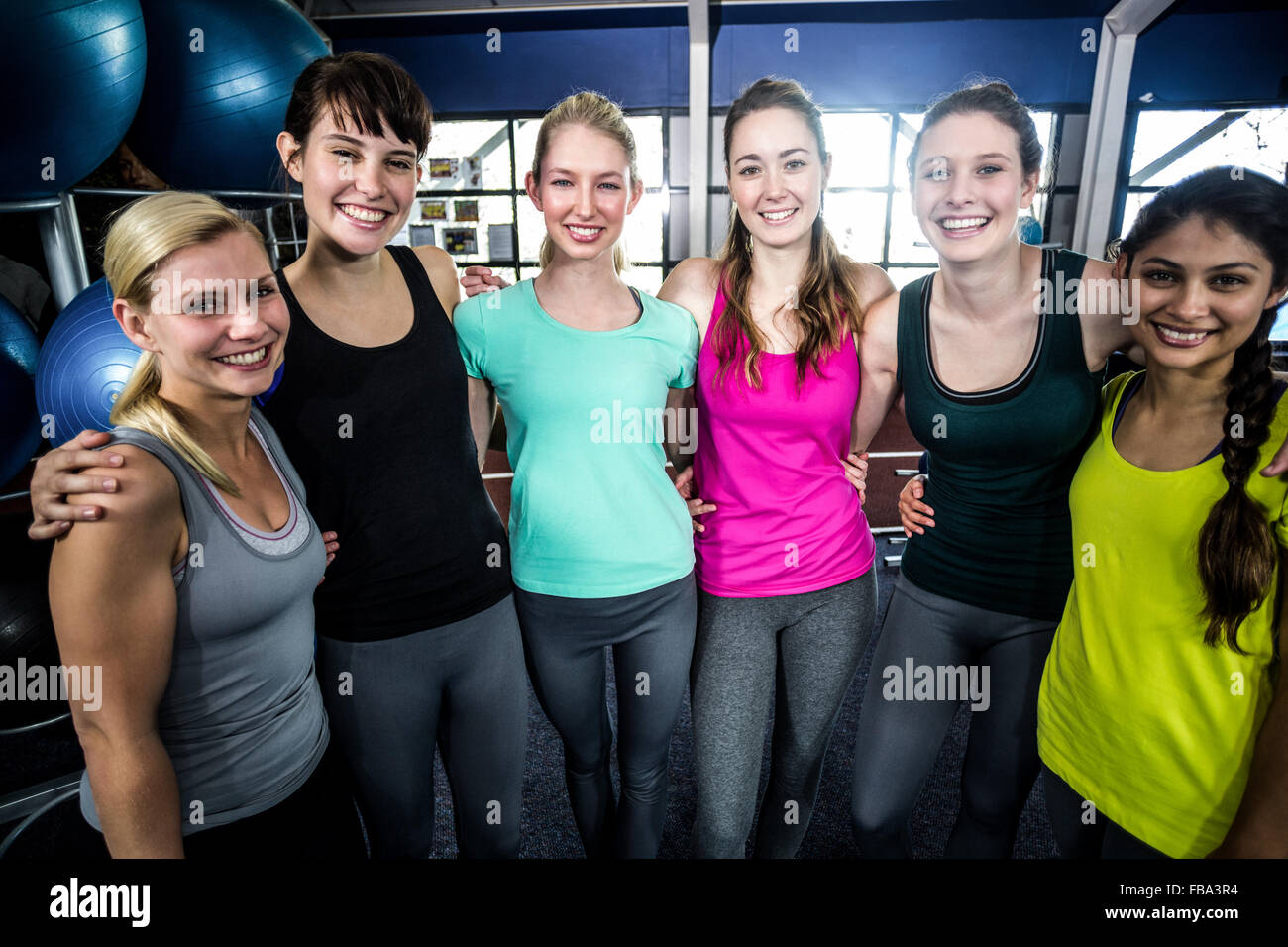 Smiling fir group posing together Stock Photo - Alamy