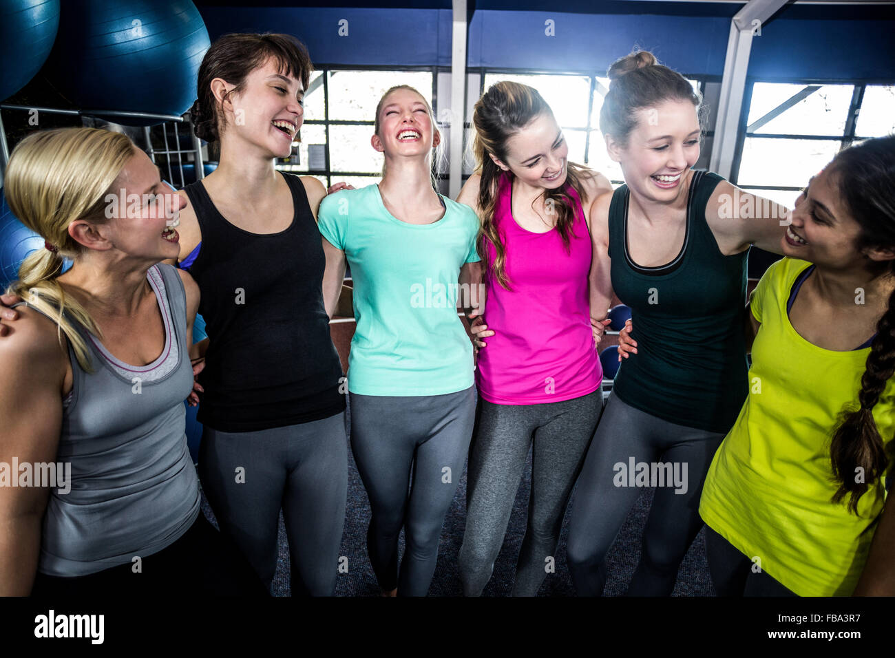 Smiling fir group posing together Stock Photo - Alamy