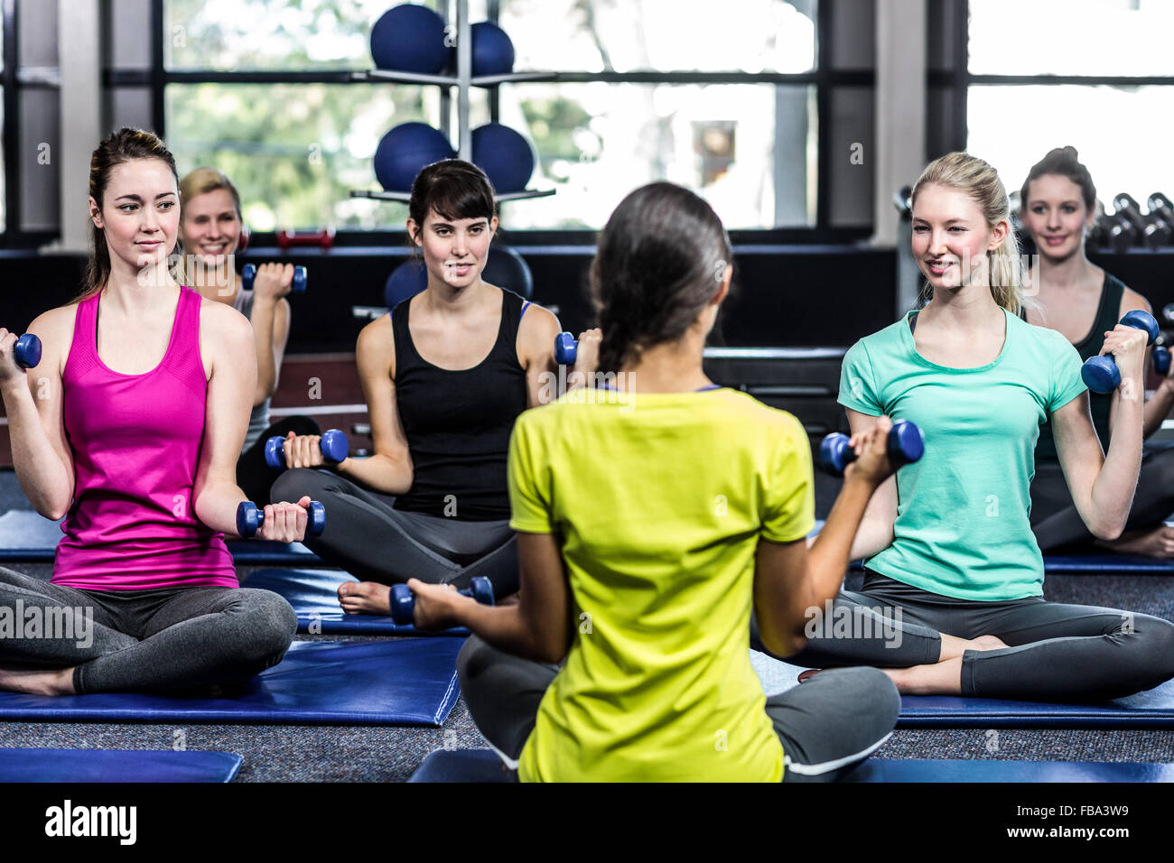 Fit smiling group doing exercise Stock Photo - Alamy