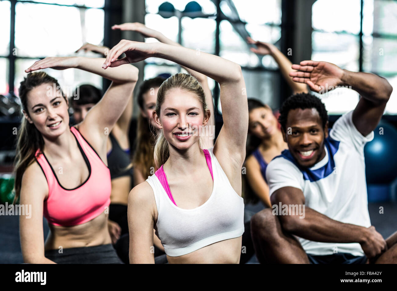 Fit smiling group doing exercise Stock Photo - Alamy