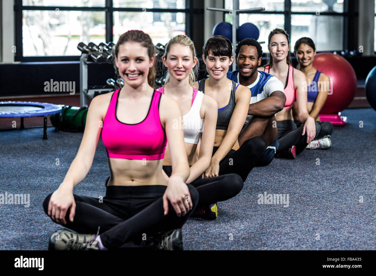 Fit smiling group doing exercise Stock Photo - Alamy