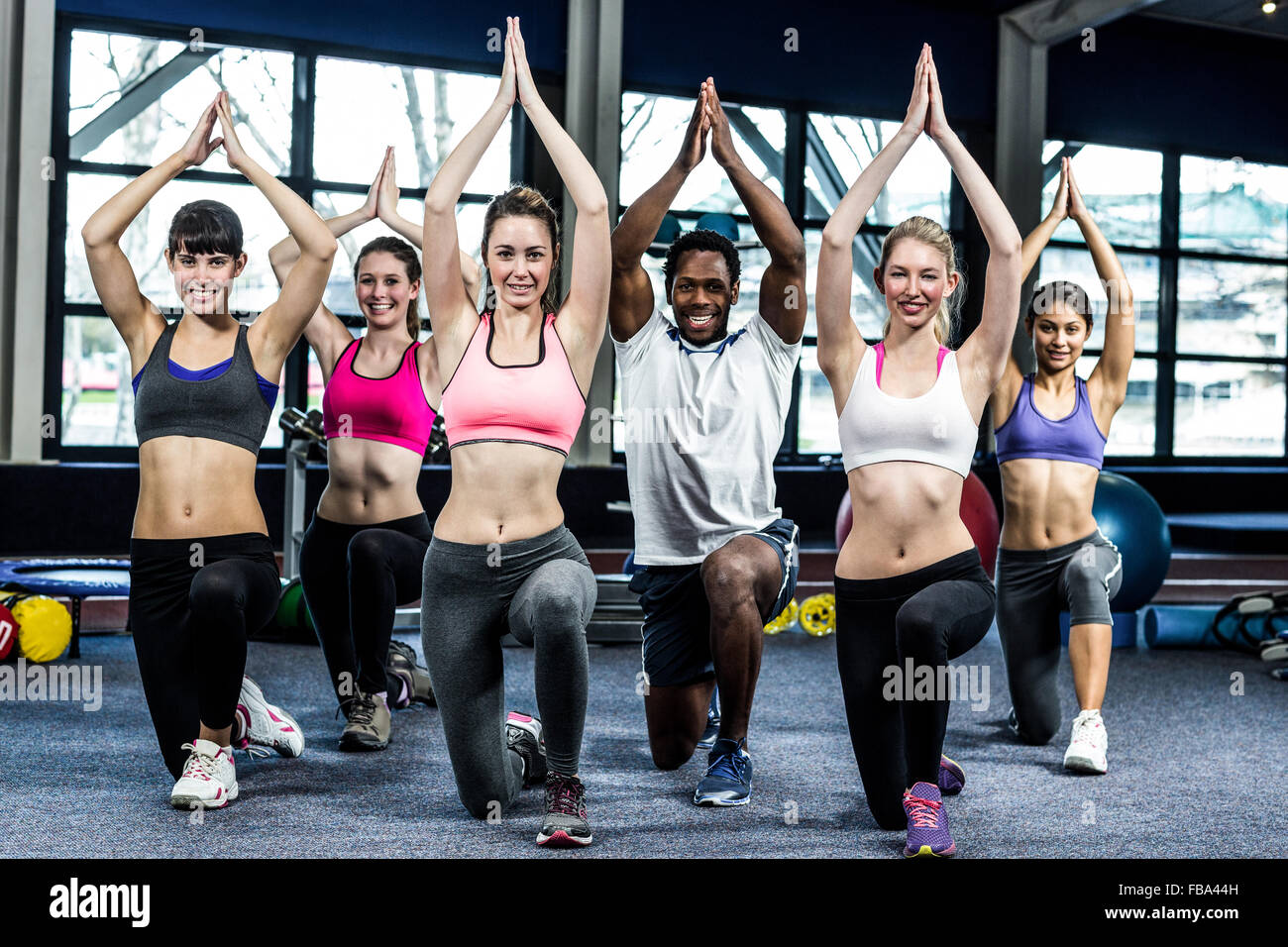 Fit smiling group doing exercise Stock Photo - Alamy