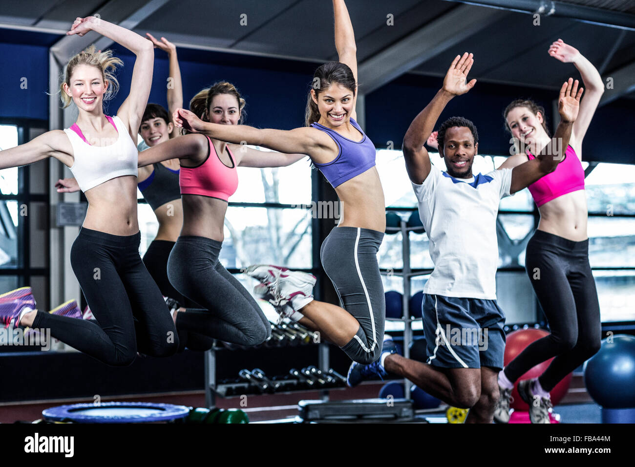 Fit group smiling and jumping Stock Photo - Alamy