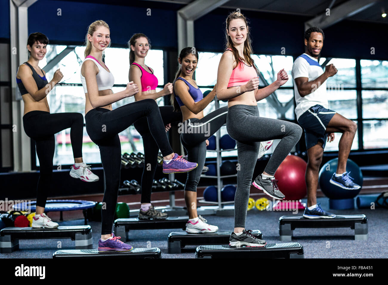 Fit smiling group doing exercise Stock Photo - Alamy