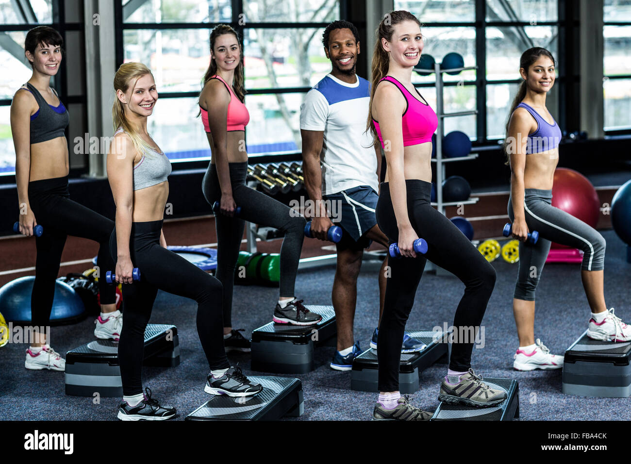 Fit smiling group doing exercise Stock Photo - Alamy