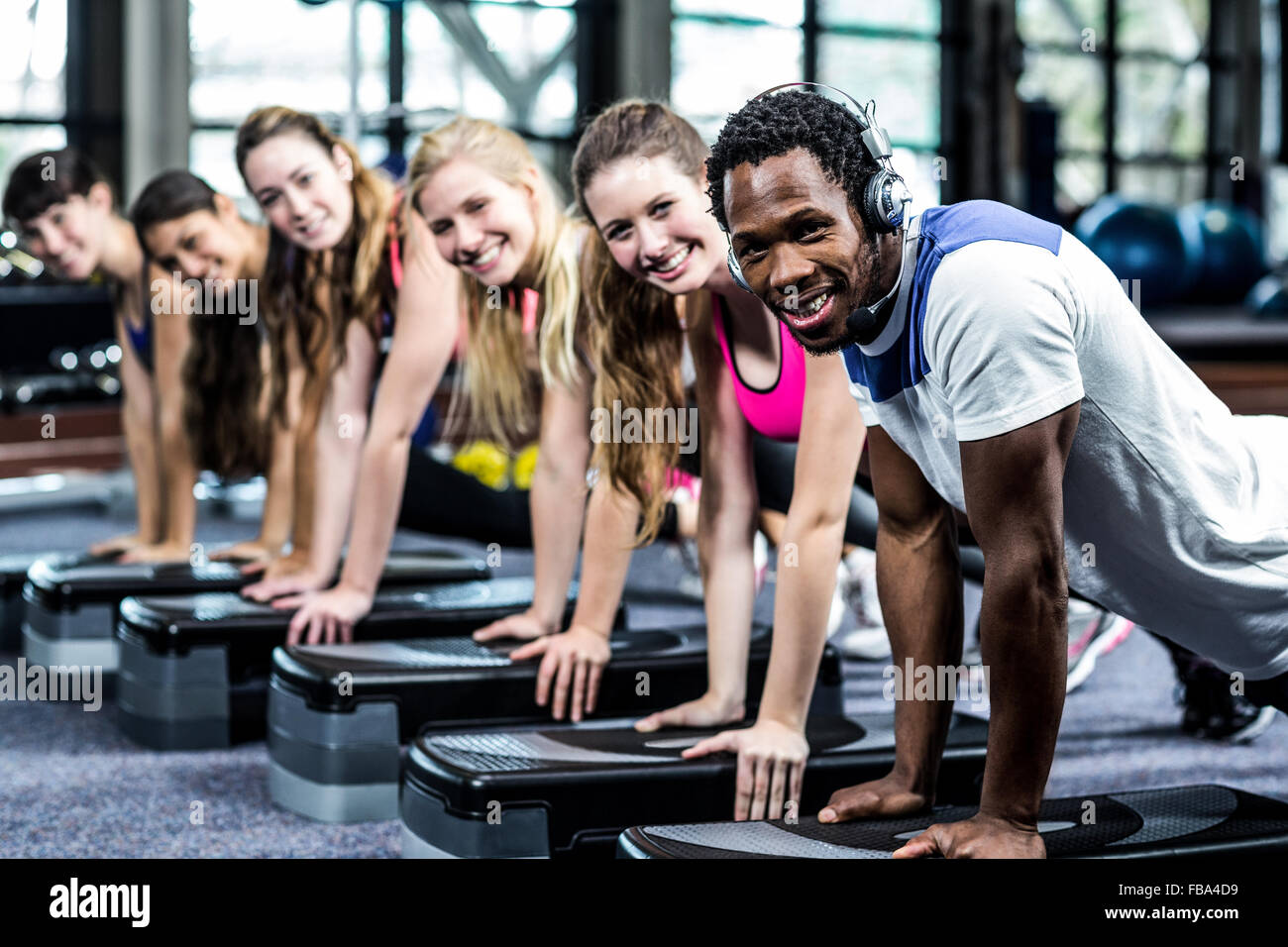 Group of fit people doing some push ups Stock Photo - Alamy