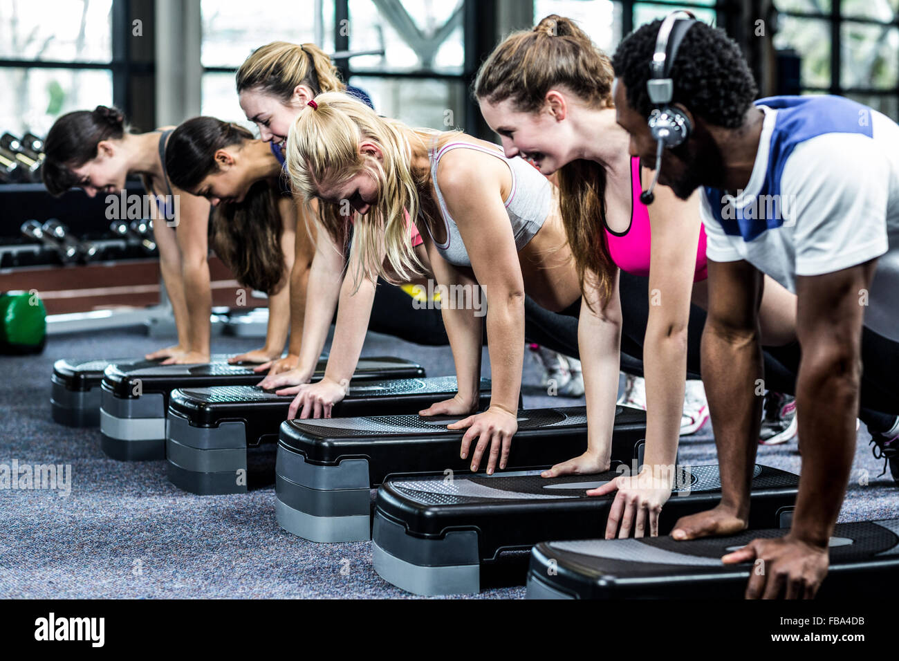 Group of fit people doing some push ups Stock Photo - Alamy