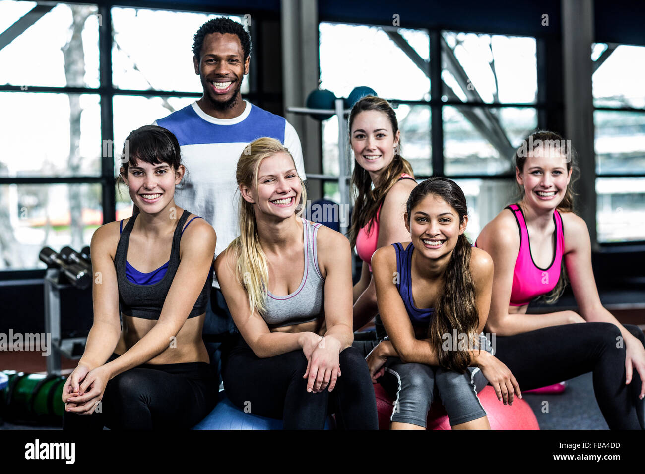 Group of fit people smiling while sitting on exercise balls Stock Photo ...