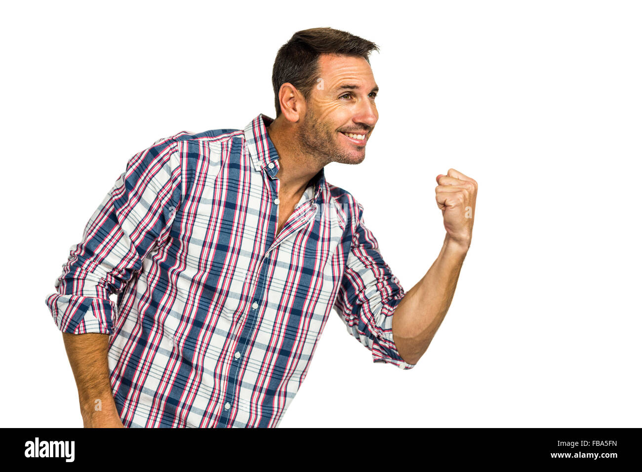 Triumphant man raising fist Stock Photo - Alamy