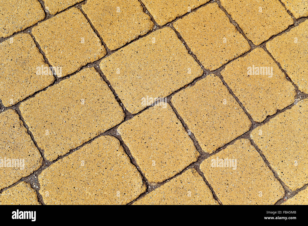 closeup of a yellow stone wall or a stone pavement background in ...