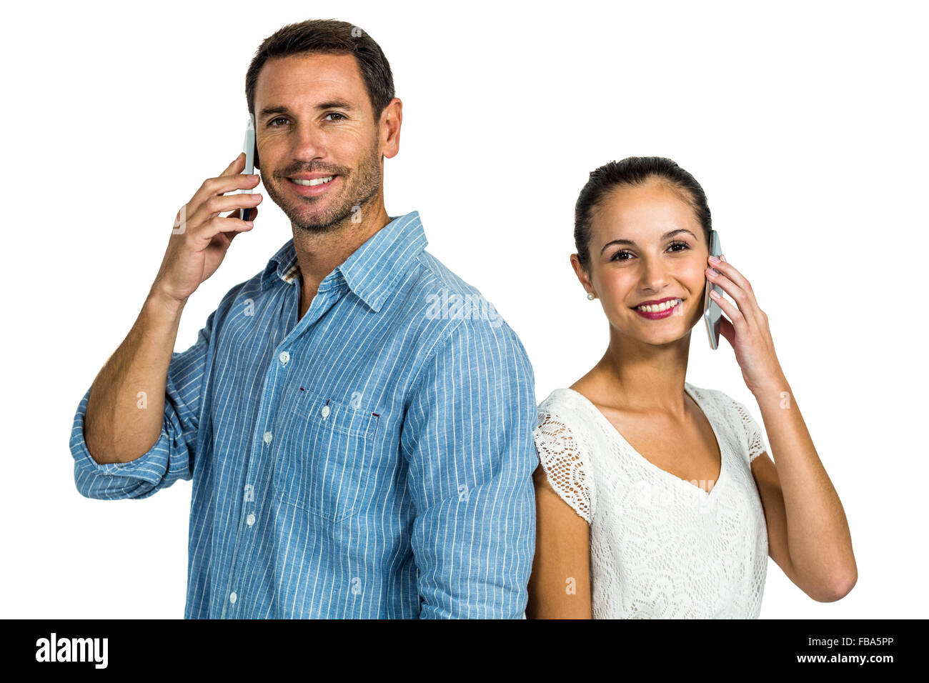Portrait of couple on phone call looking at the camera Stock Photo - Alamy