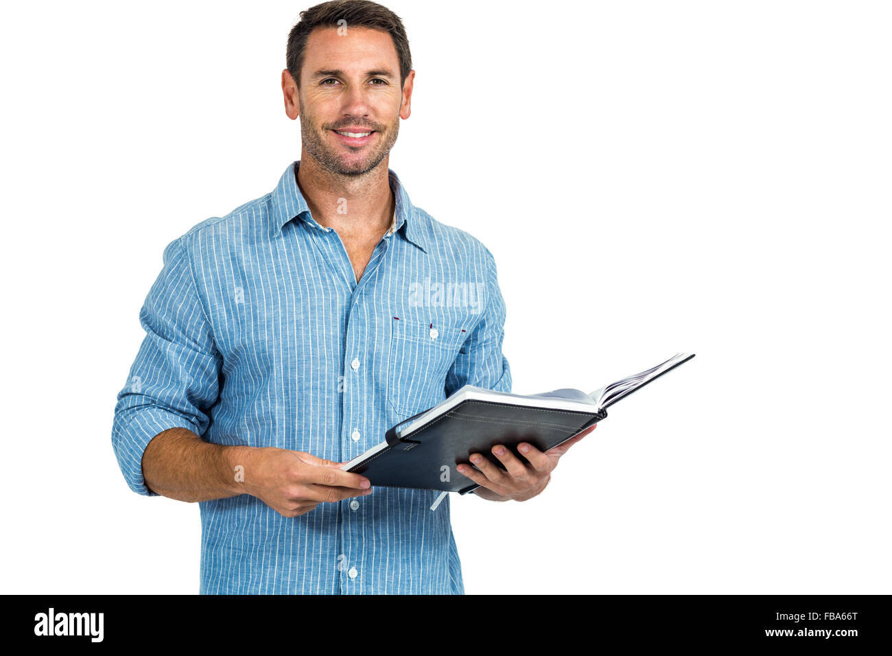 Smiling man holding book Stock Photo - Alamy