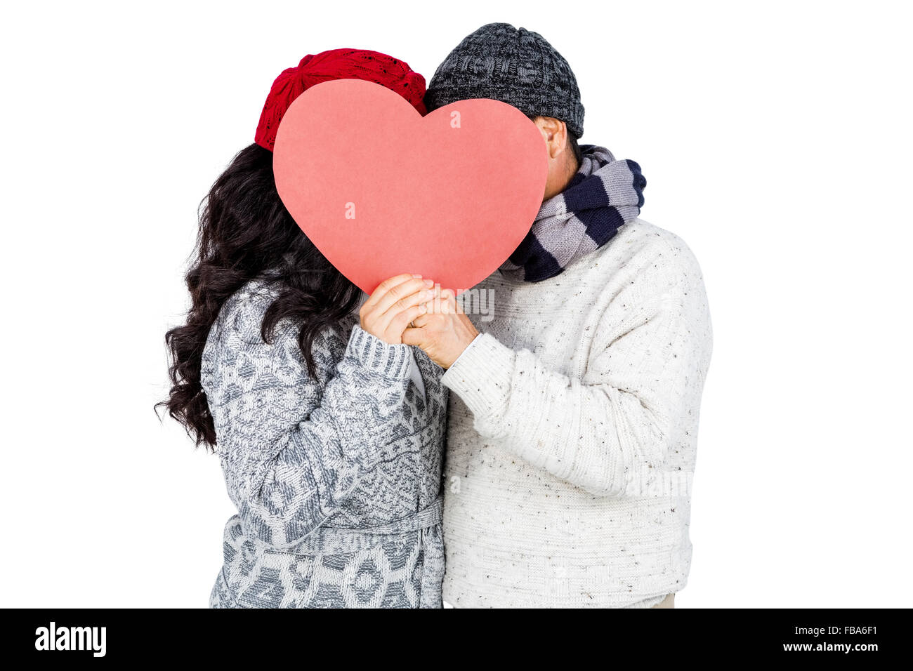 Couple hiding behind heart shape cardboard Stock Photo - Alamy