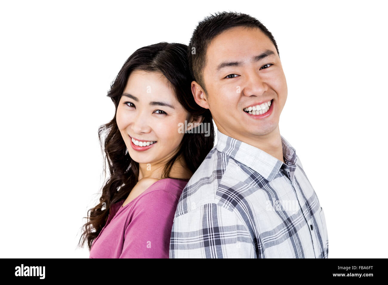 Asian couple smiling at camera Stock Photo - Alamy