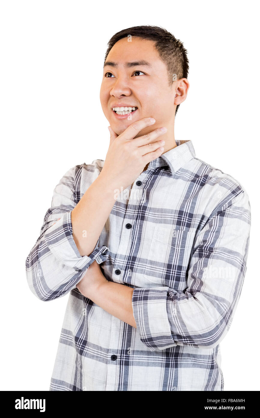 Happy young man with hand on chin Stock Photo - Alamy