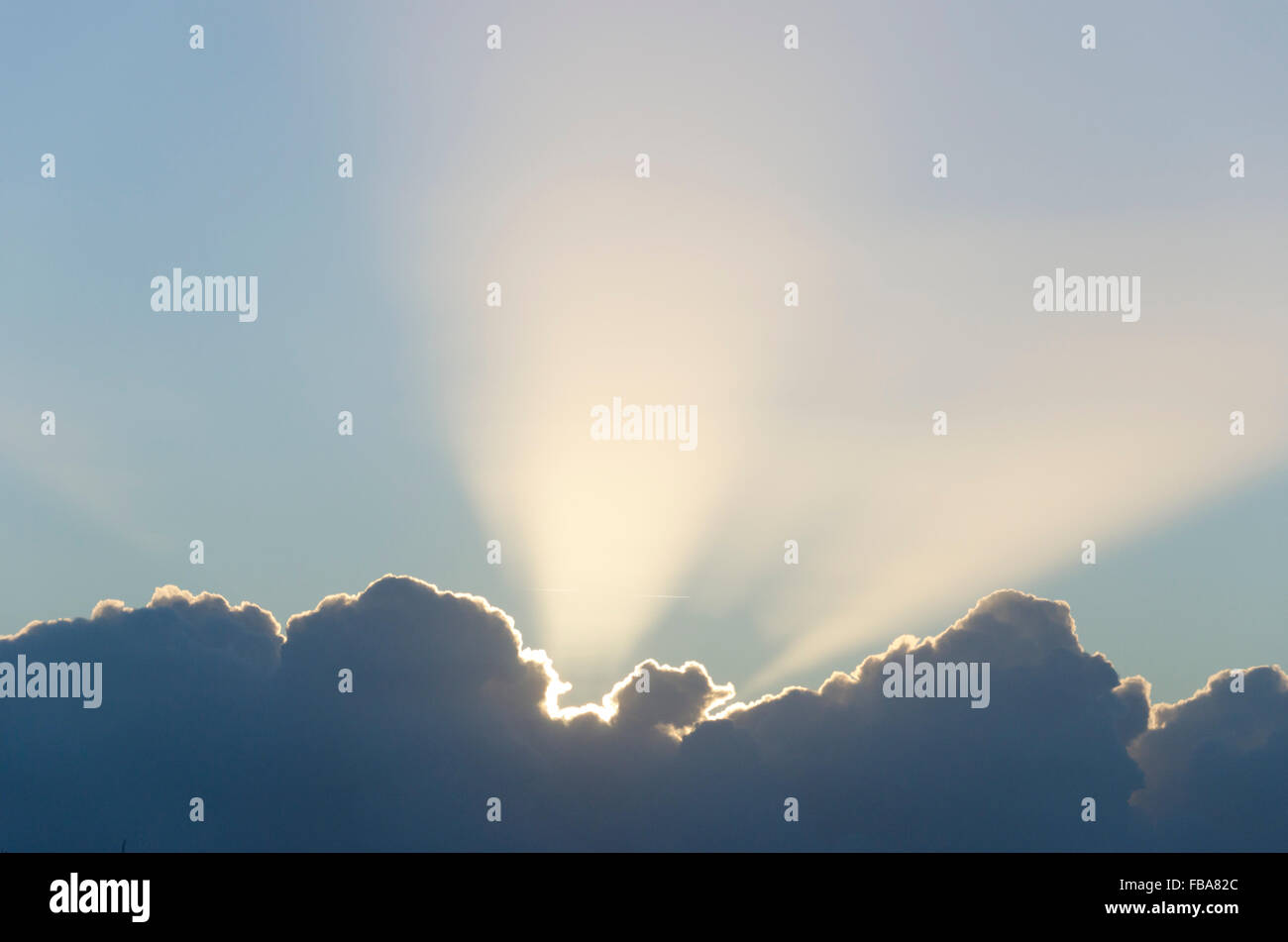 Sun rising beyond clouds Stock Photo - Alamy