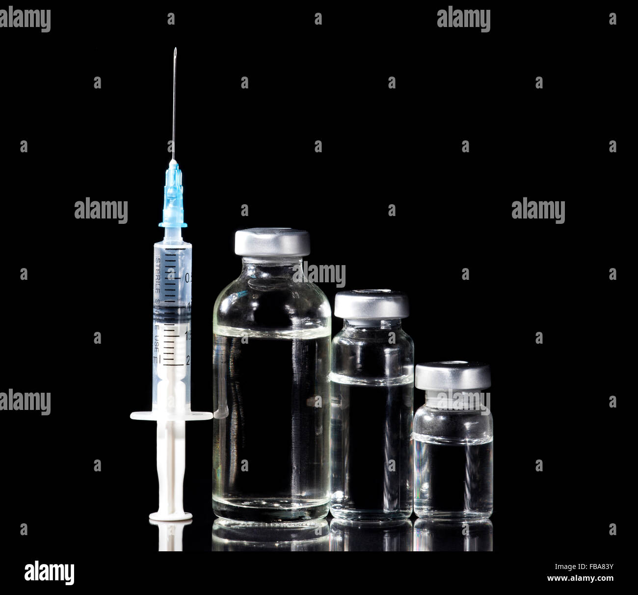 Glass Medicine Vials and Syringe on black background Stock Photo - Alamy