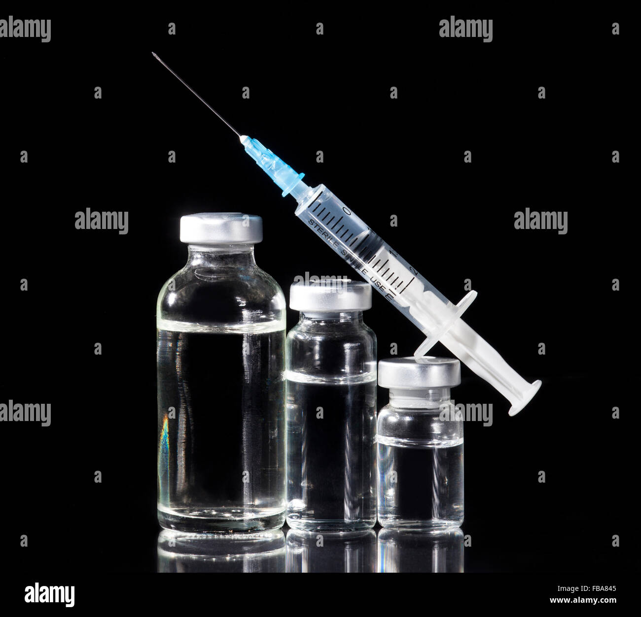 Glass Medicine Vials and Syringe on black background Stock Photo - Alamy