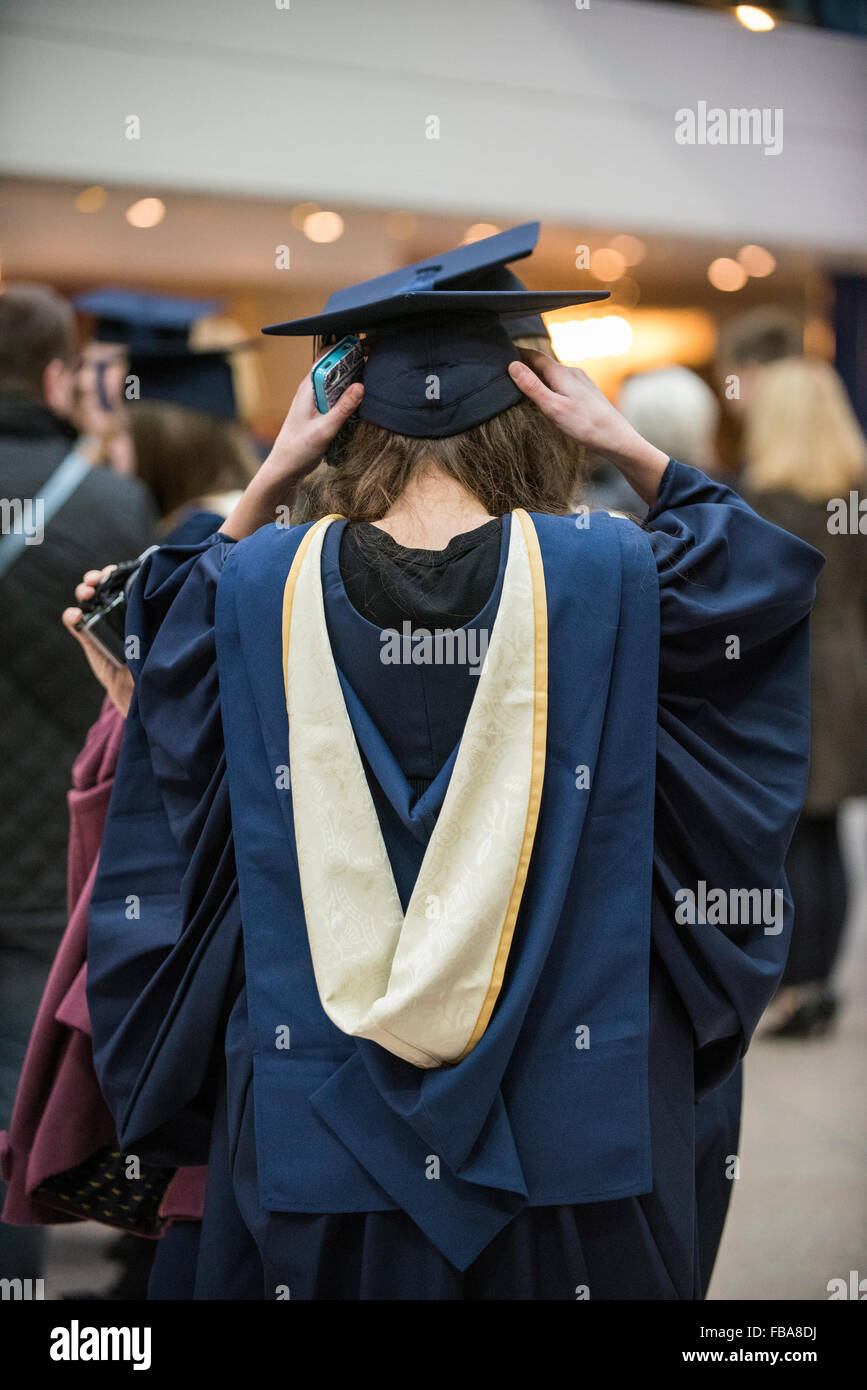 Young female graduand holding cap, graduation ceremony, UK Stock Photo ...