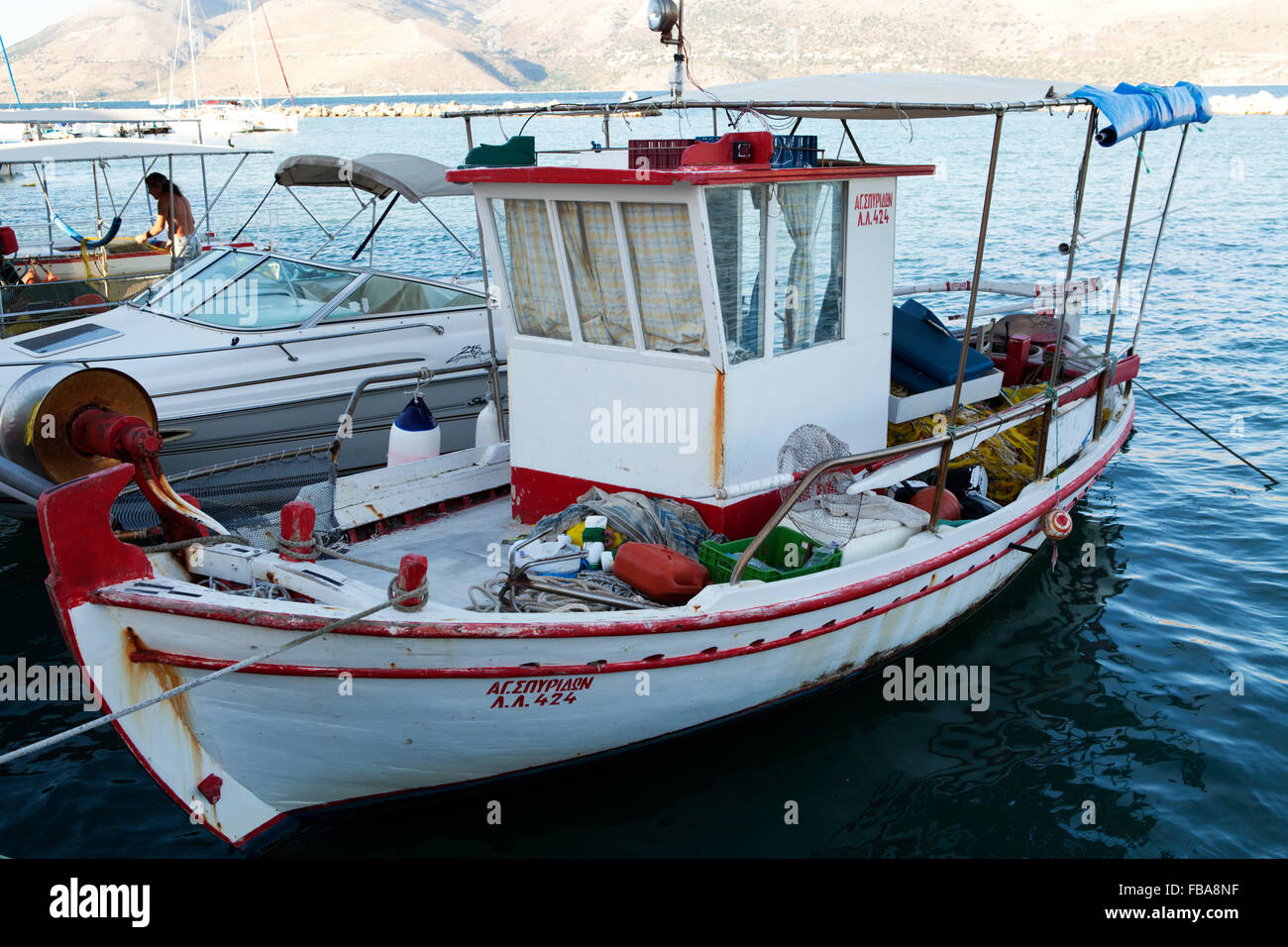 Traditional Greek fishing boats harbored at Lixouri during the day ...