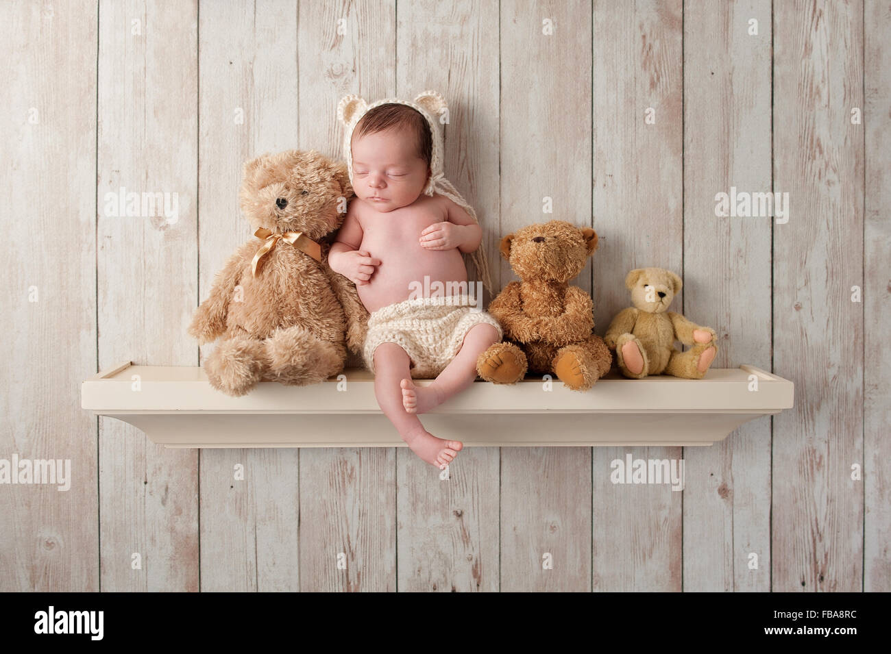 Three week old newborn baby boy wearing a cream colored crocheted bear ...