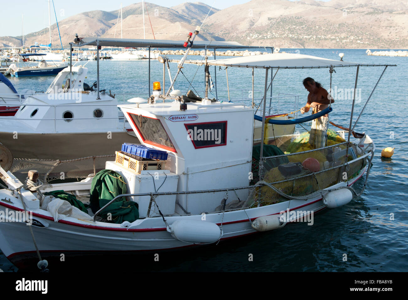 Traditional Greek fishing boats harbored at Lixouri during the day ...