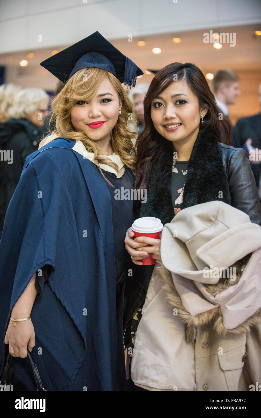 Happy, smiling international graduand and family, graduation ceremony ...