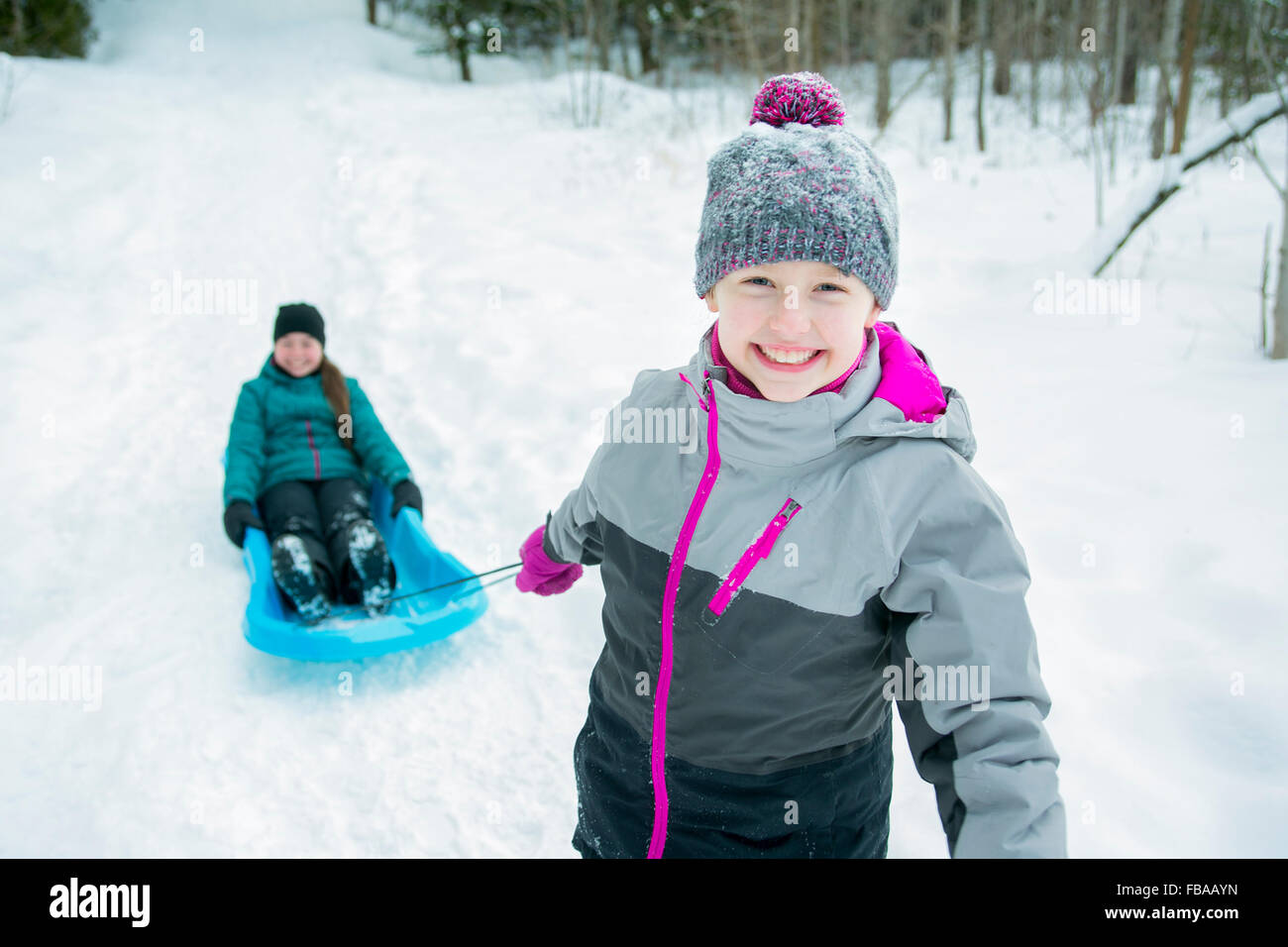 Children Pulling Sledge Through Snowy Landscape Stock Photo - Alamy