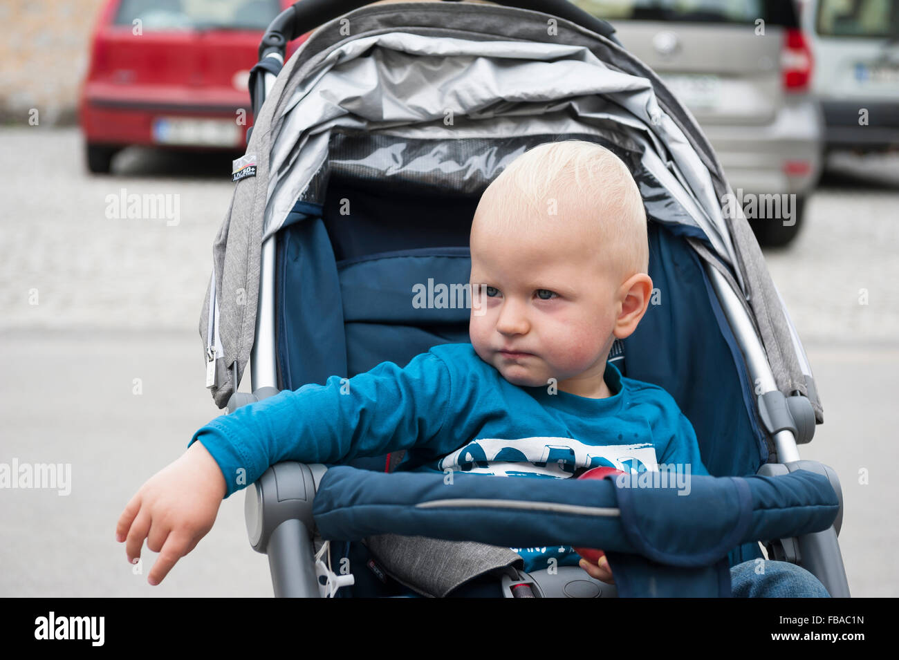 Toddler sitting in a stroller Stock Photo - Alamy