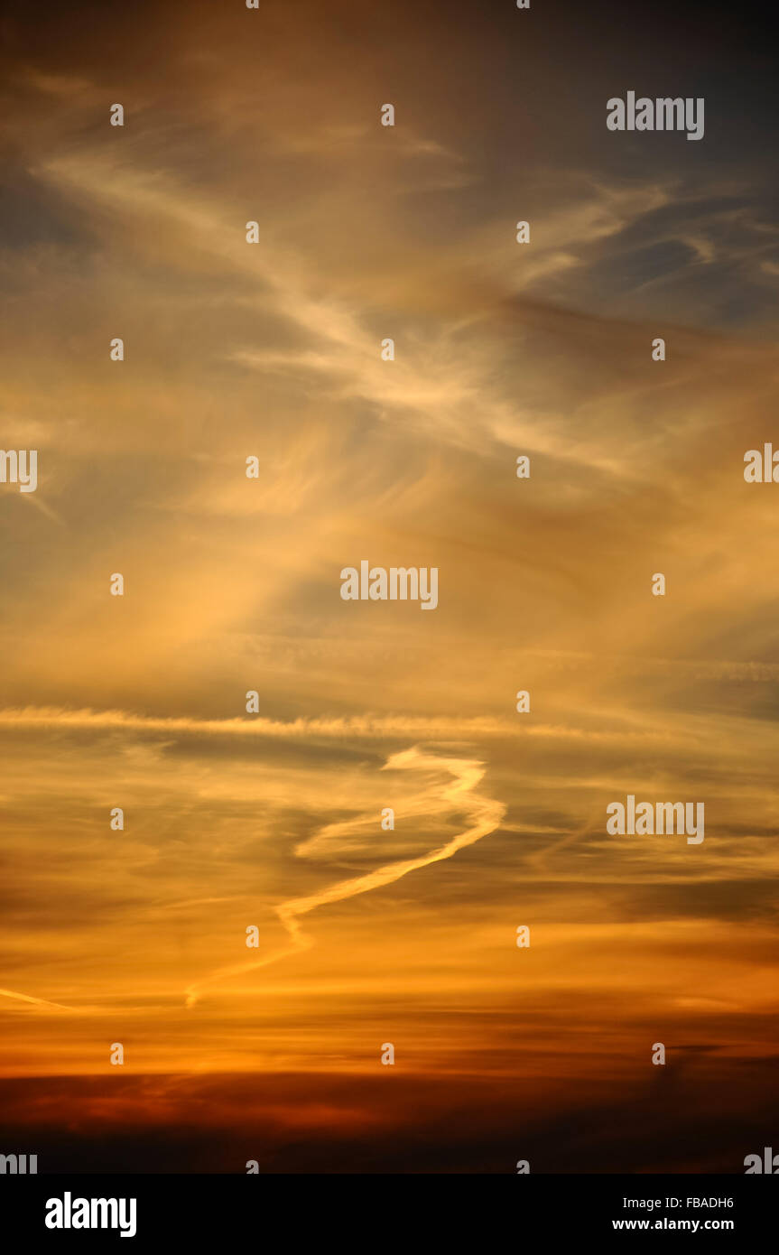 Beautiful abstract sunset with high wispy clouds glowing with warm ...
