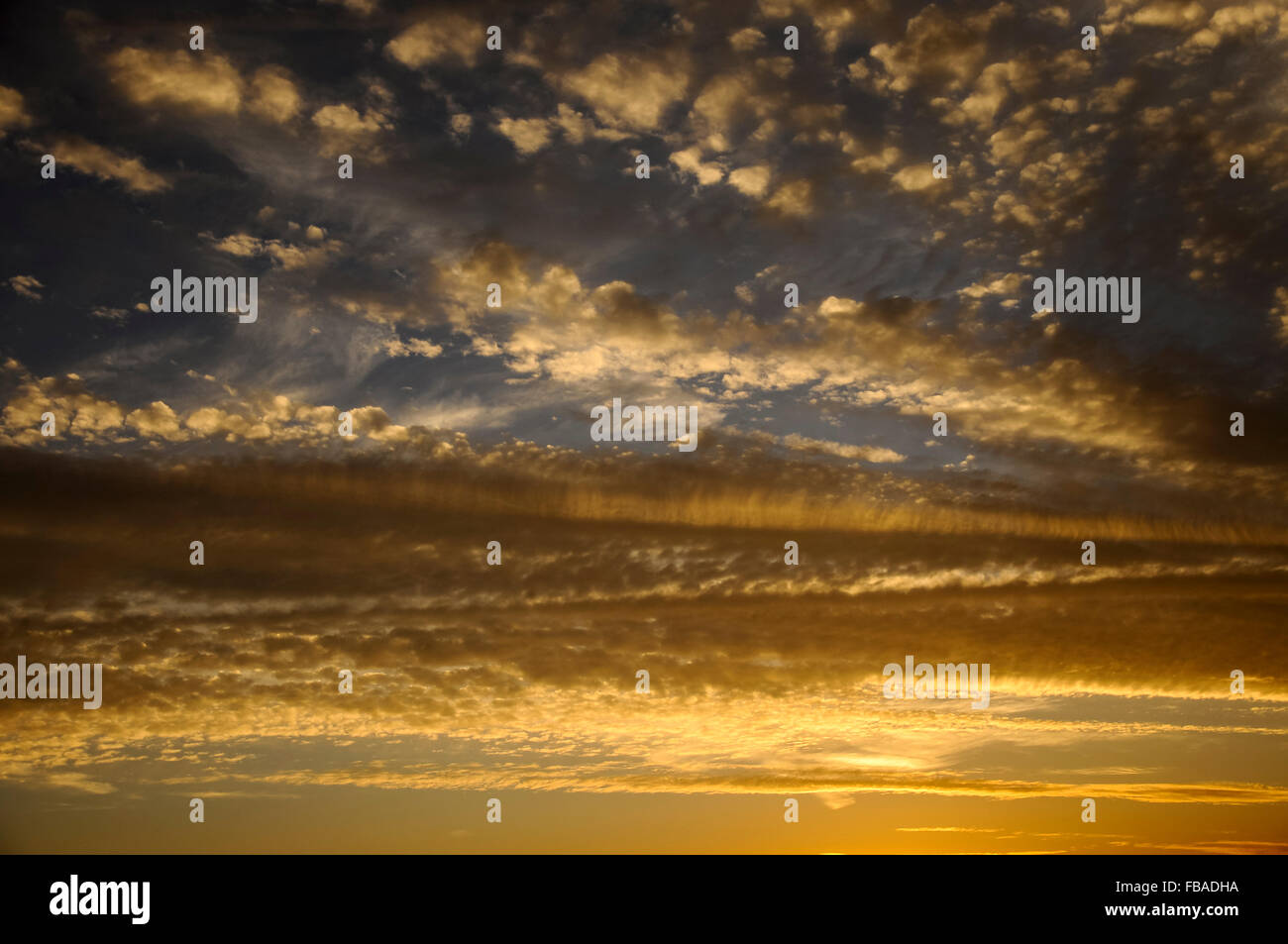 Beautiful abstract sunset with high wispy clouds glowing with warm ...