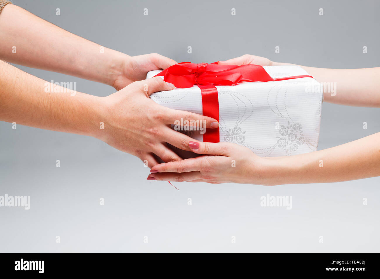 Hands giving and receiving a present Stock Photo - Alamy