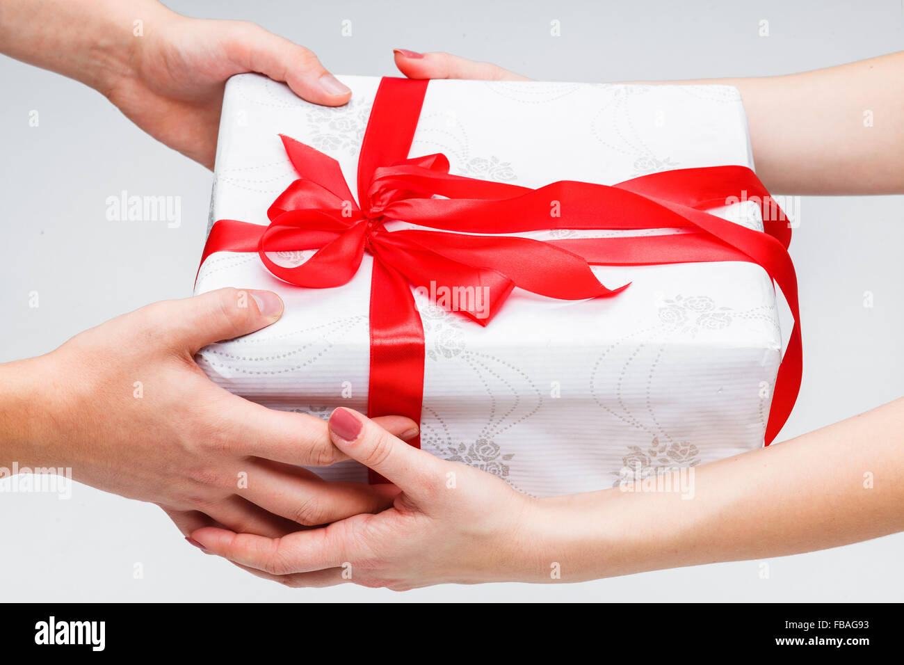 Hands giving and receiving a present Stock Photo - Alamy