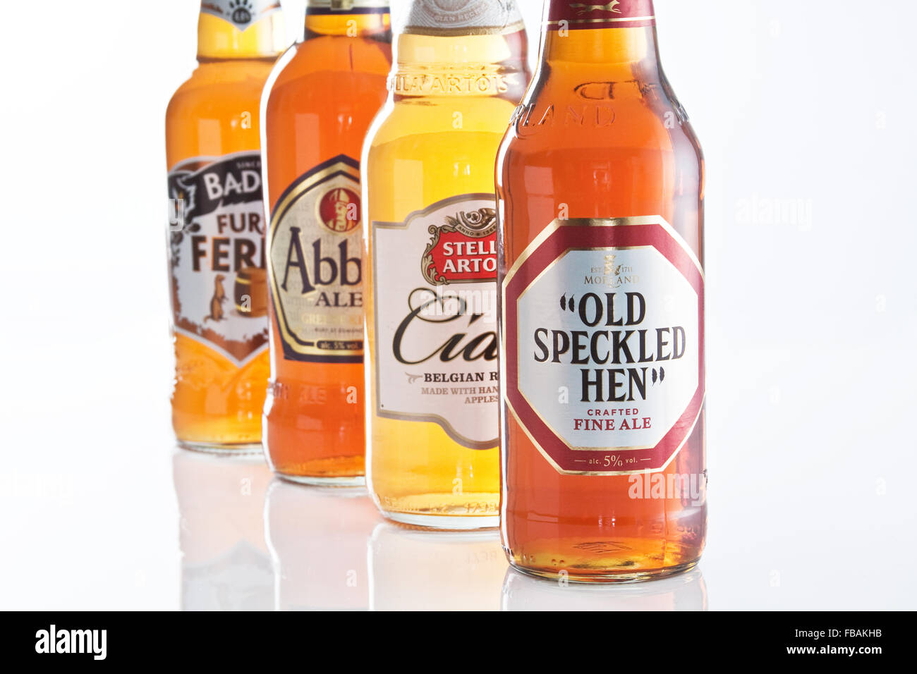 Four colourful beer and cider bottles arranged to show depth of field ...
