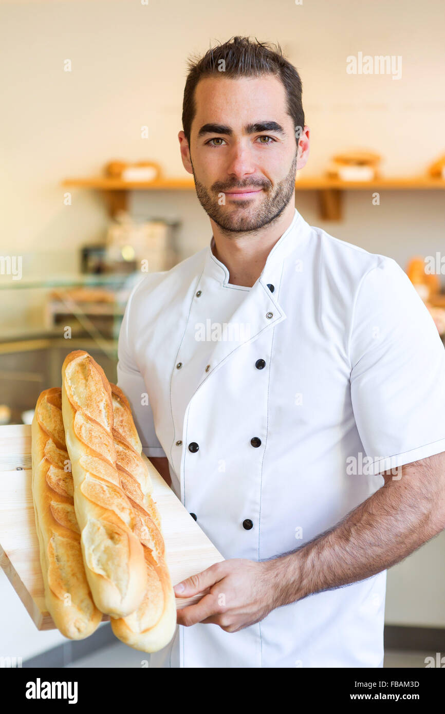 VIew of a Young attarctive baker working at the bakery Stock Photo - Alamy