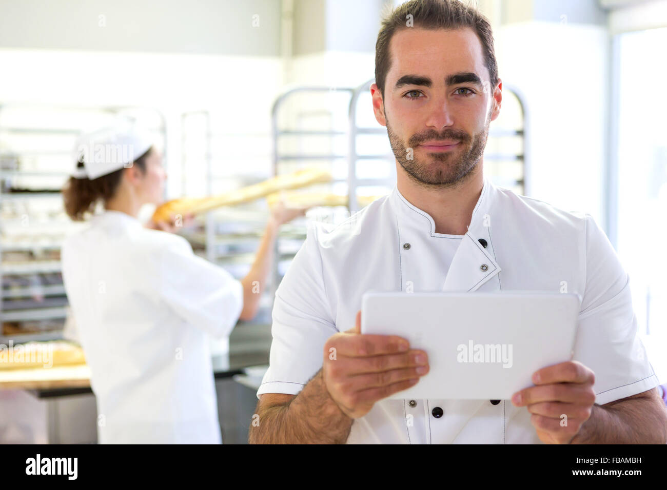 VIew of a Young attarctive baker working at the bakery Stock Photo - Alamy