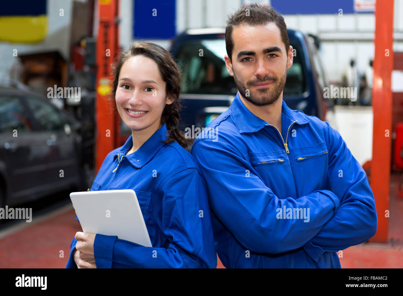 View of a Team of mechanics working at the garage Stock Photo - Alamy