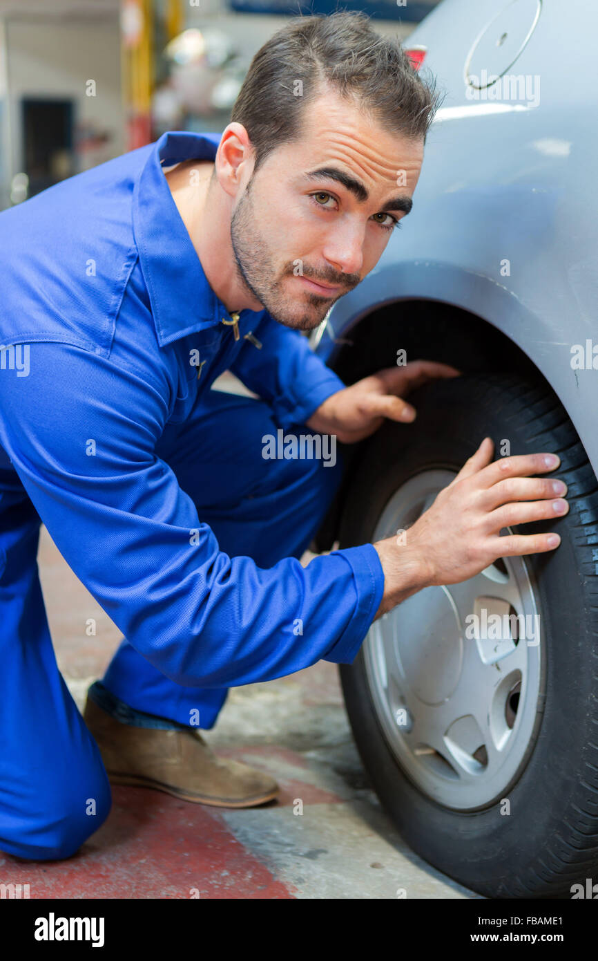 View of a Young attractive mechanic working on a car at the garage Stock Photo - Alamy